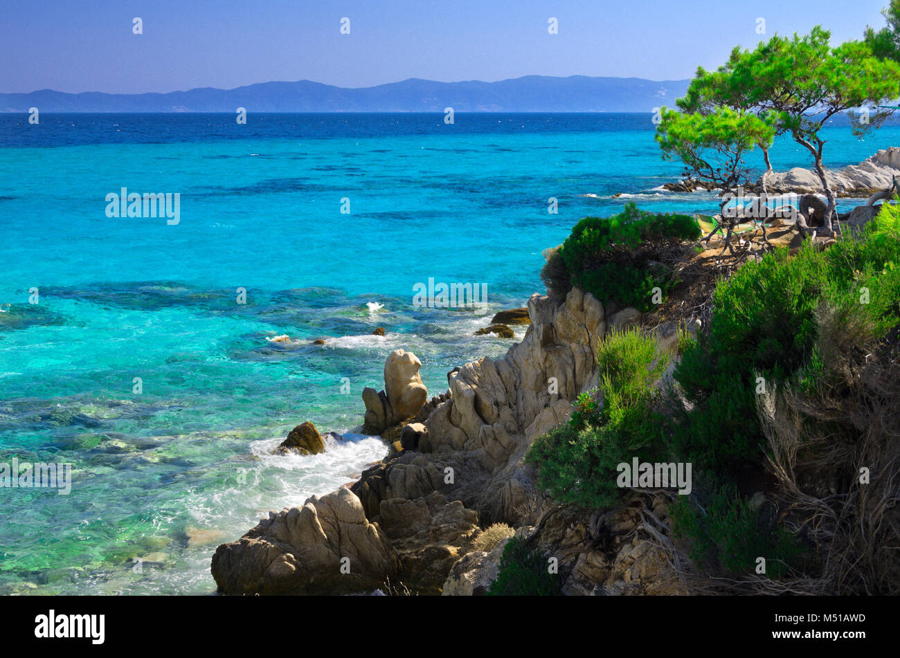 Blue sea shore under clear sky Stock Photo - Alamy