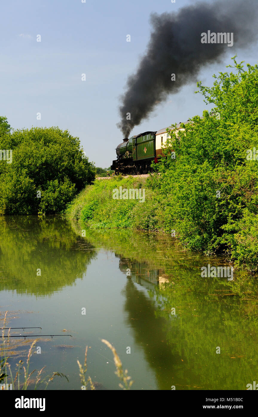 Steam train reflected in the Kennet and Avon canal, hauled by GWR loco ...