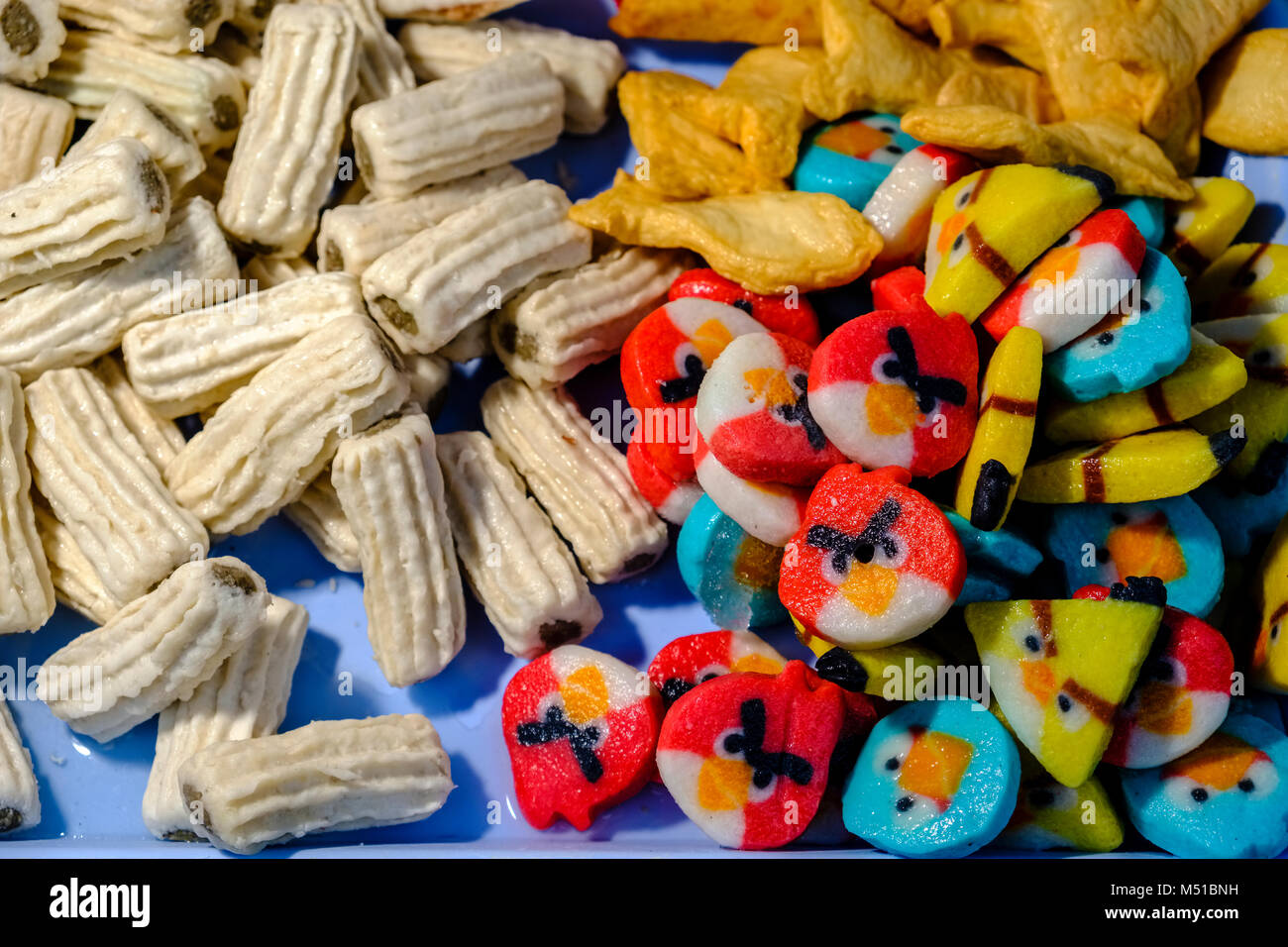 Colorful food pieces made from fish powder are displayed to get fried ...