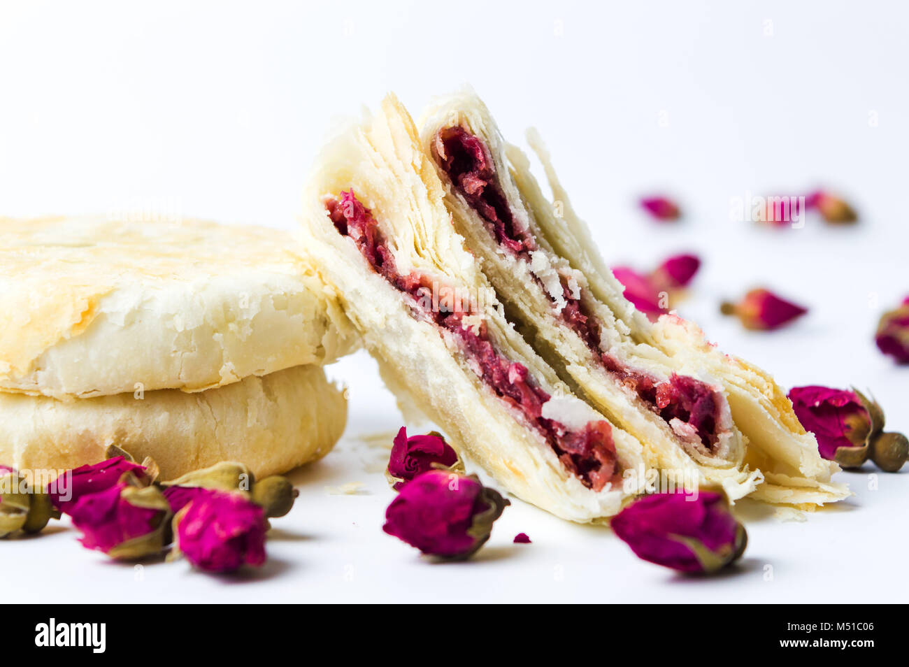 Rose pastry with natural flowers tea on white background Stock Photo ...