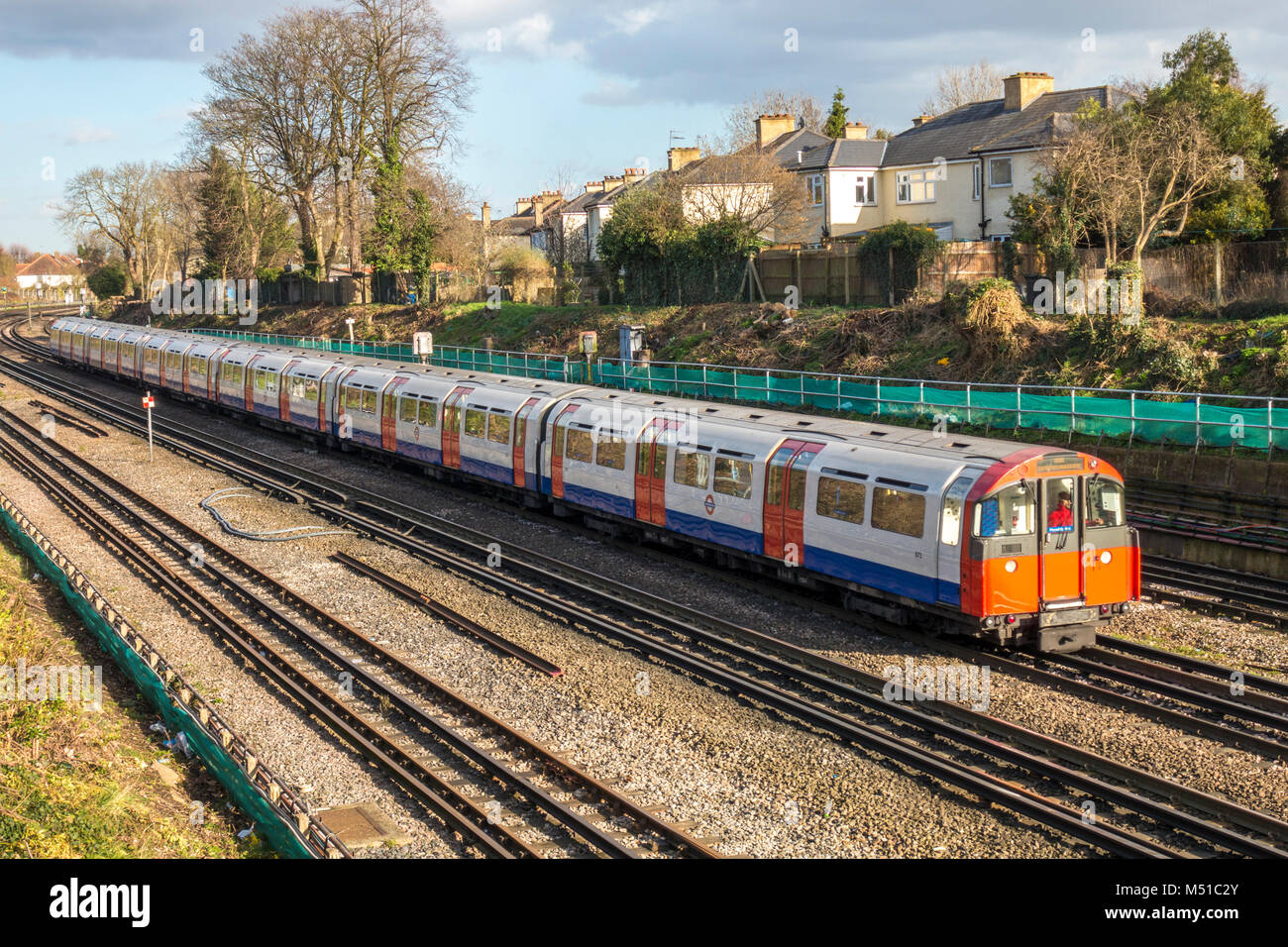 London Underground (LUL) tube train, travelling overground, approaching ...