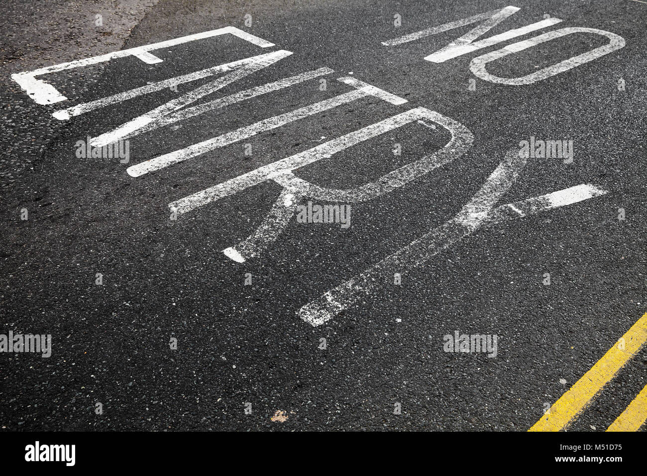 No Entry, white text road marking over dark urban asphalt pavement ...