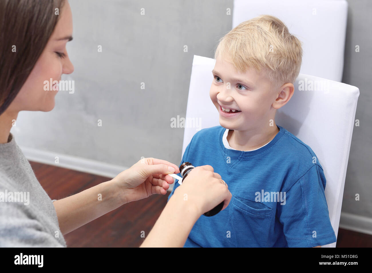 Delicious syrup. Smiling boy is drinking a cure Stock Photo - Alamy