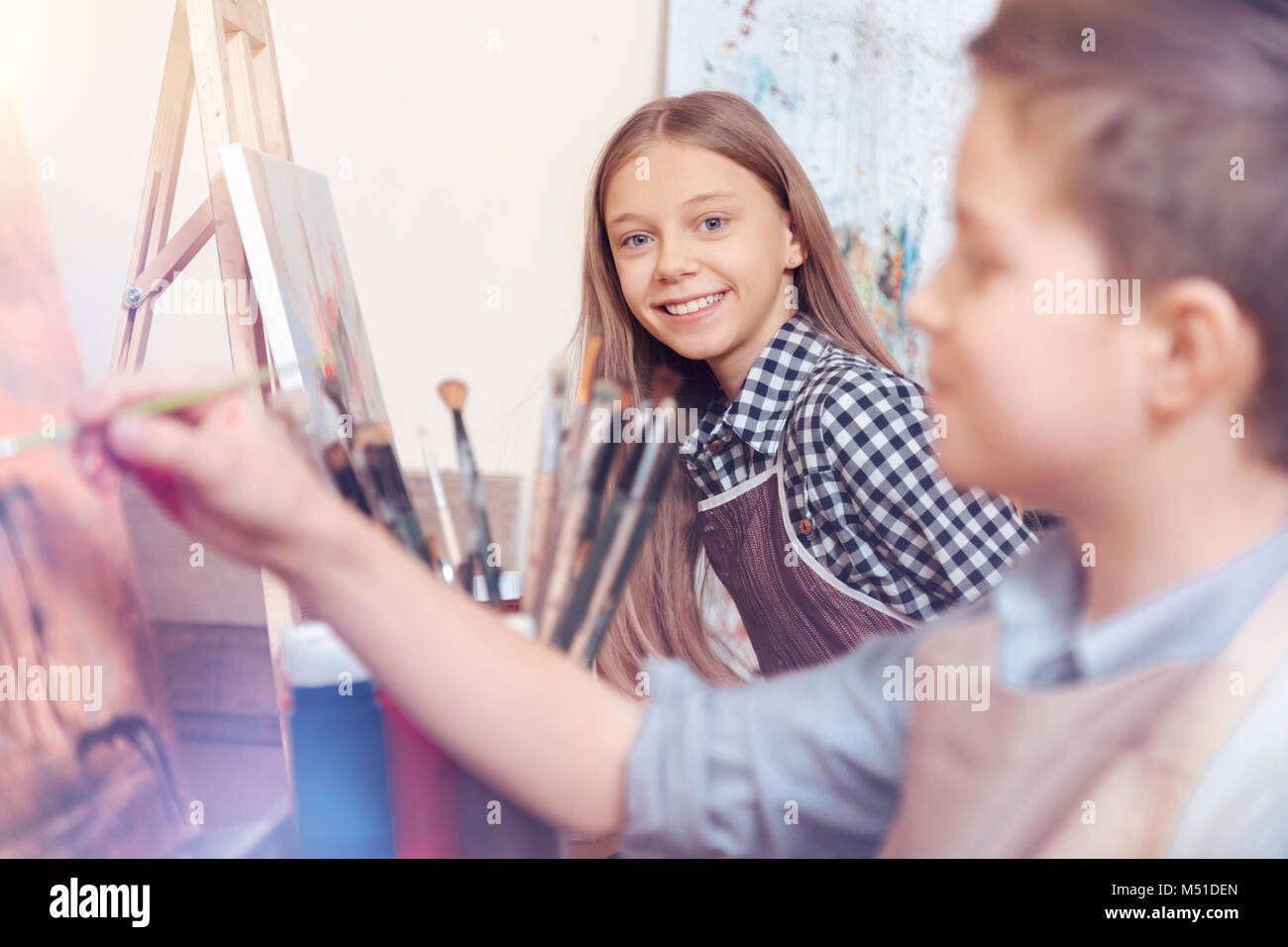 Smiling children painting on art canvas Stock Photo - Alamy