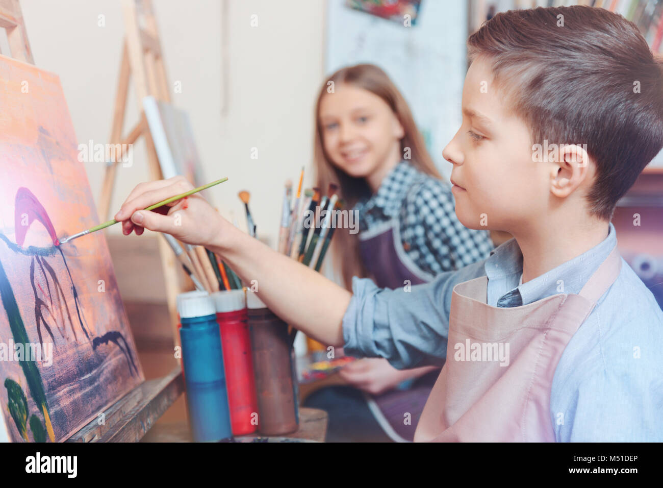 Cheerful kids painting together Stock Photo - Alamy