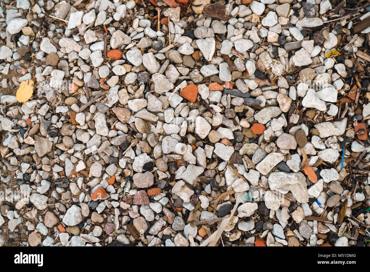 pebble beach with small pieces of waste, background Stock Photo - Alamy