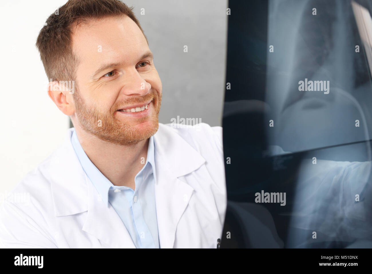 Orthopaedist. A doctor in a doctor's office is watching an x-ray of a ...