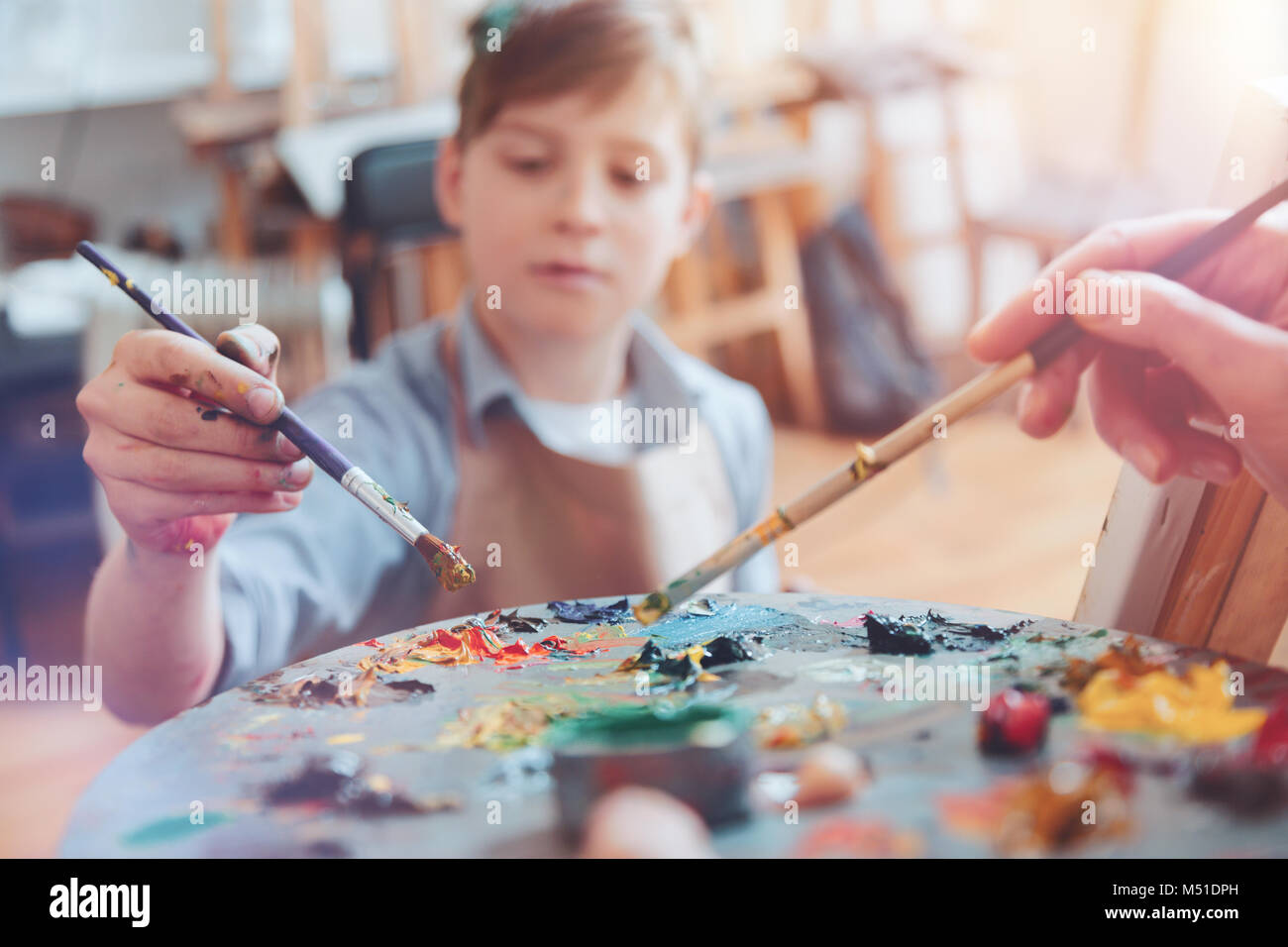 Scaled up look on child mixing paints on palette Stock Photo - Alamy