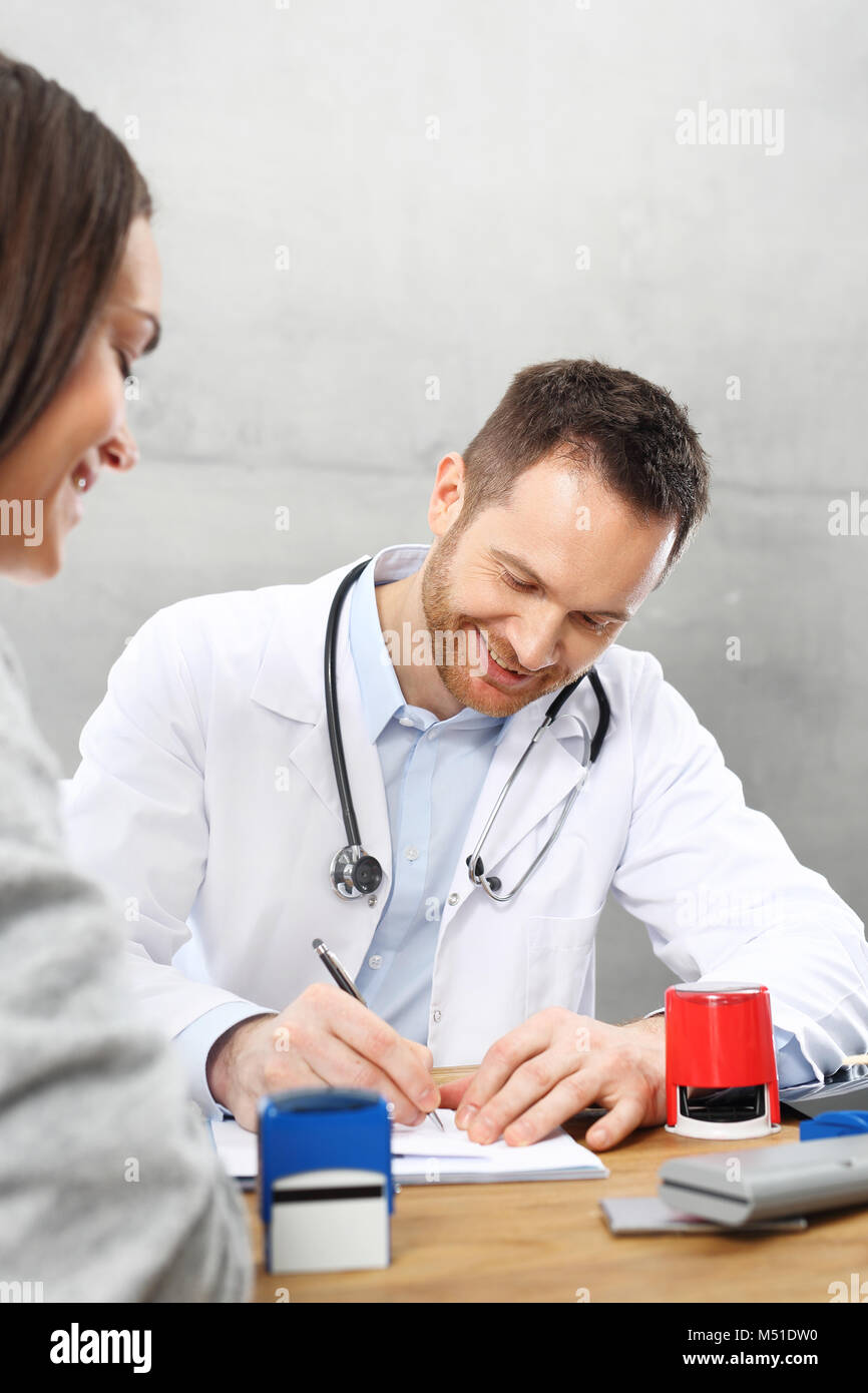 A patient in a doctor's office. The doctor enters recommendations and ...