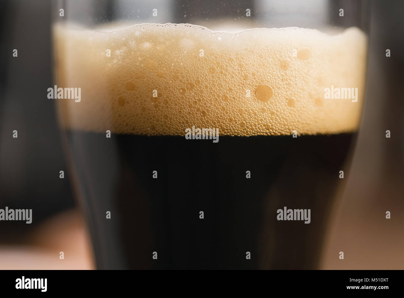 closeup glass of stout beer, shallow focus Stock Photo - Alamy