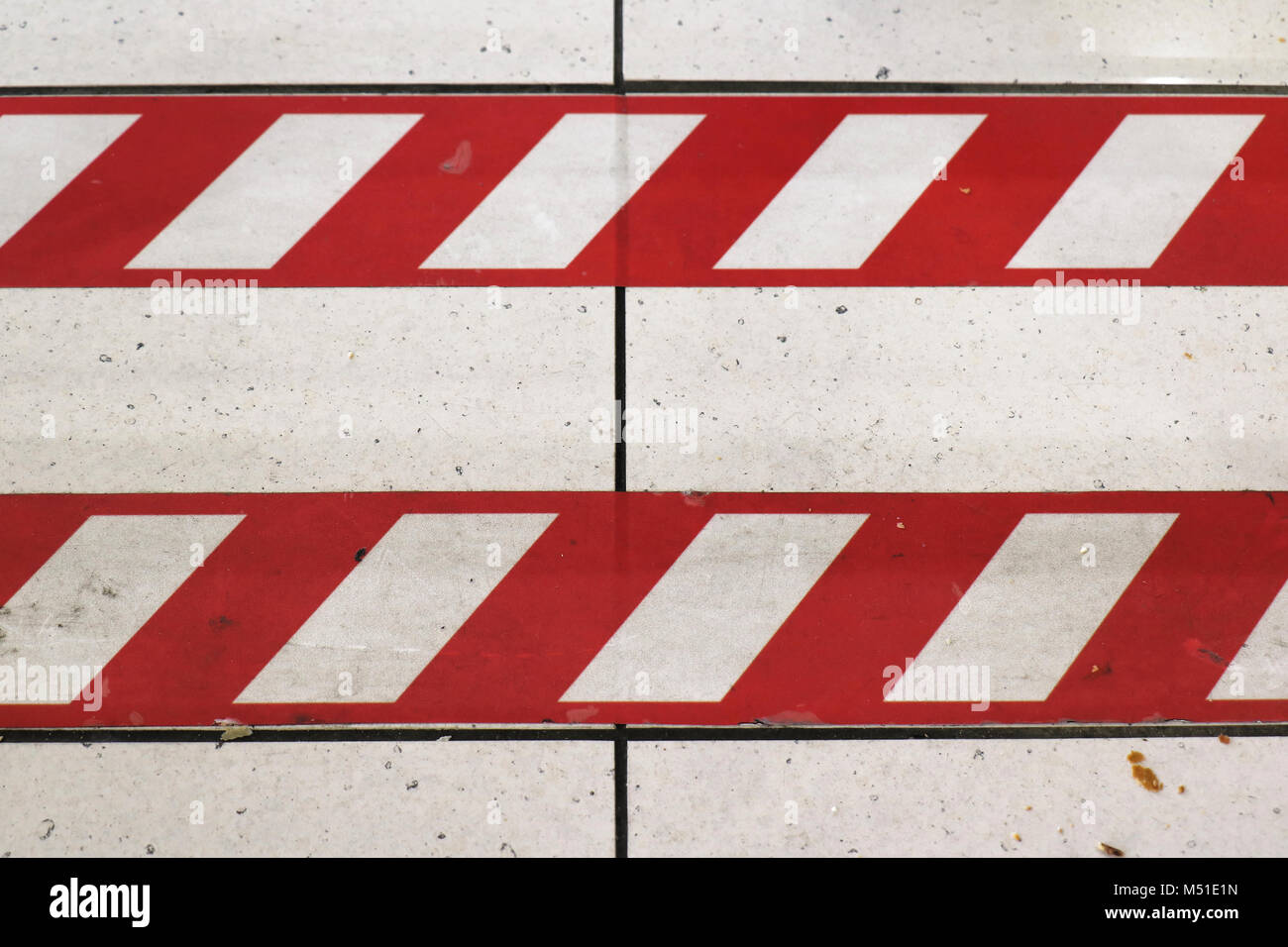 Red stripes lines marking safety zone on the floor Stock Photo - Alamy