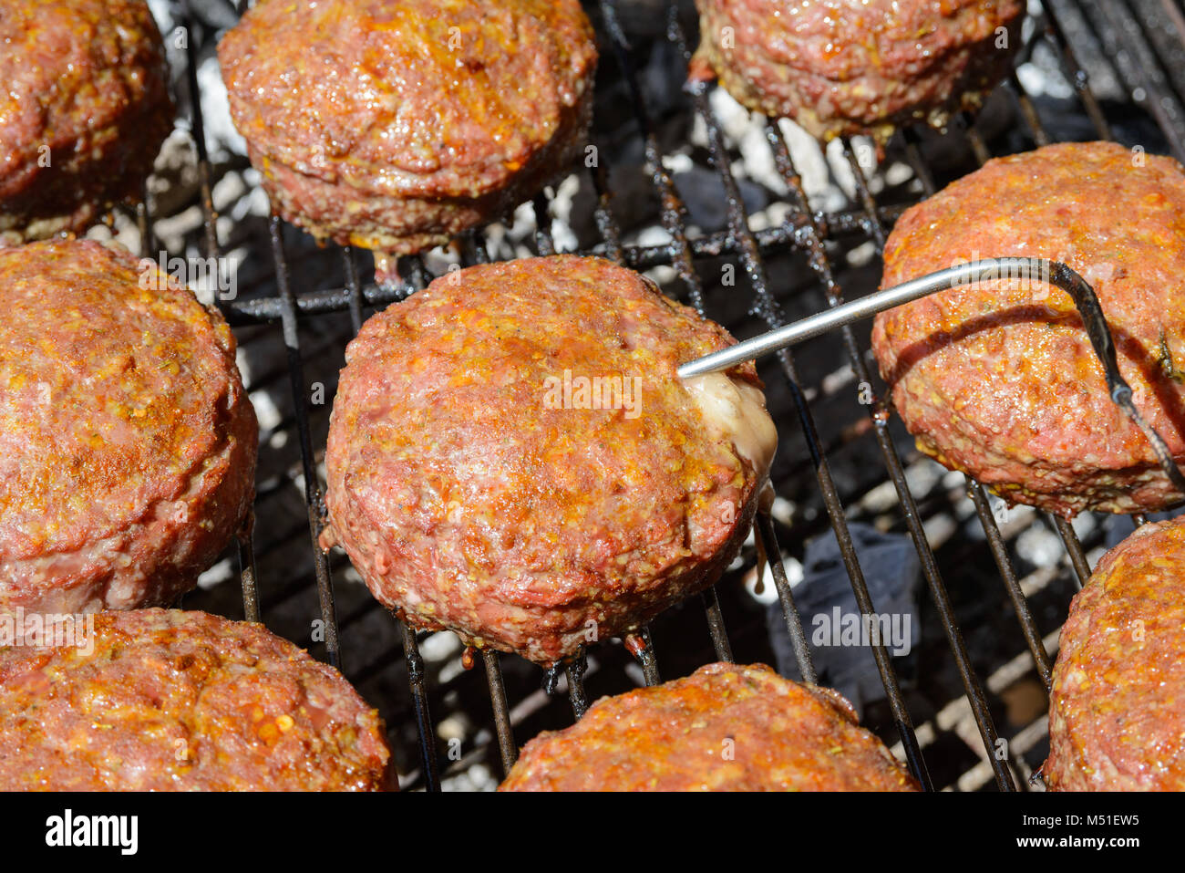 Big beef and cheese hamburger baking inside the barbecue Stock Photo ...