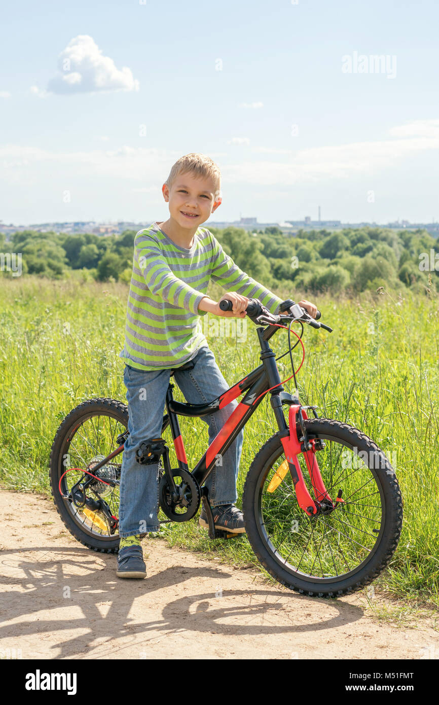 Happy boy running on the field Stock Photo - Alamy