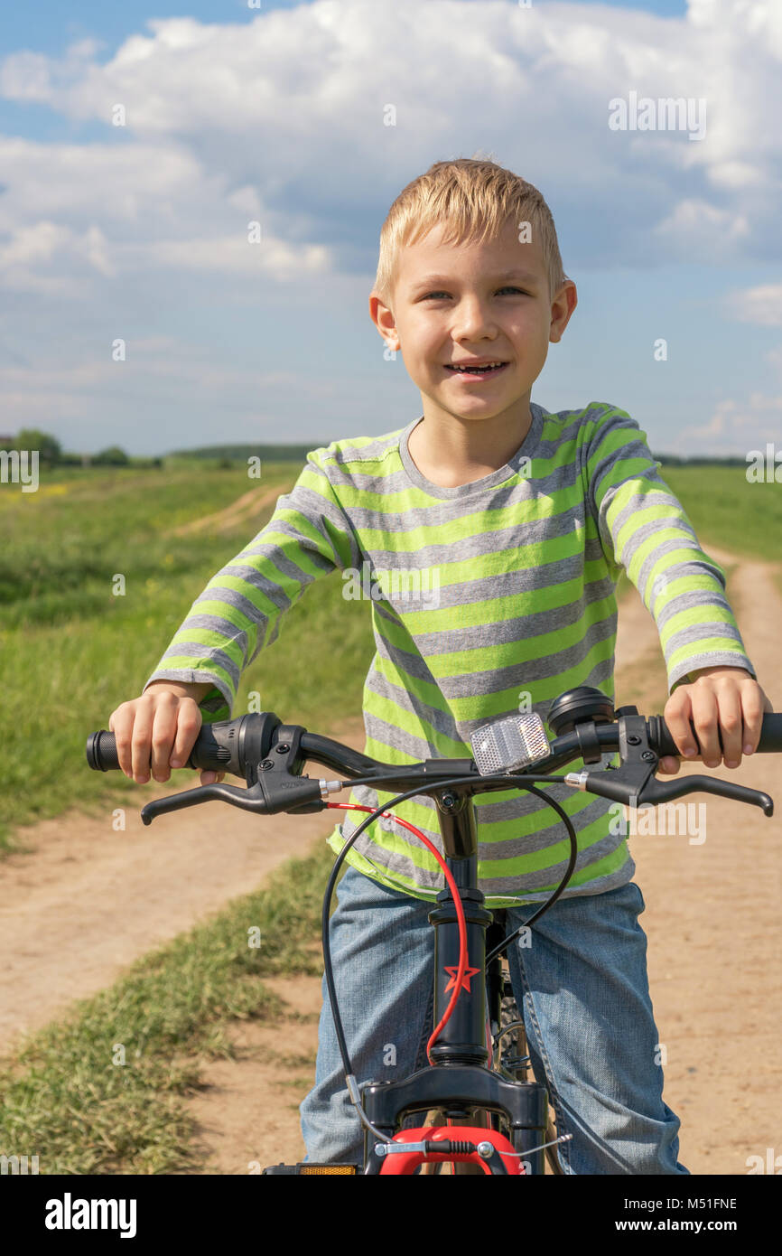 Happy boy running on the field Stock Photo - Alamy
