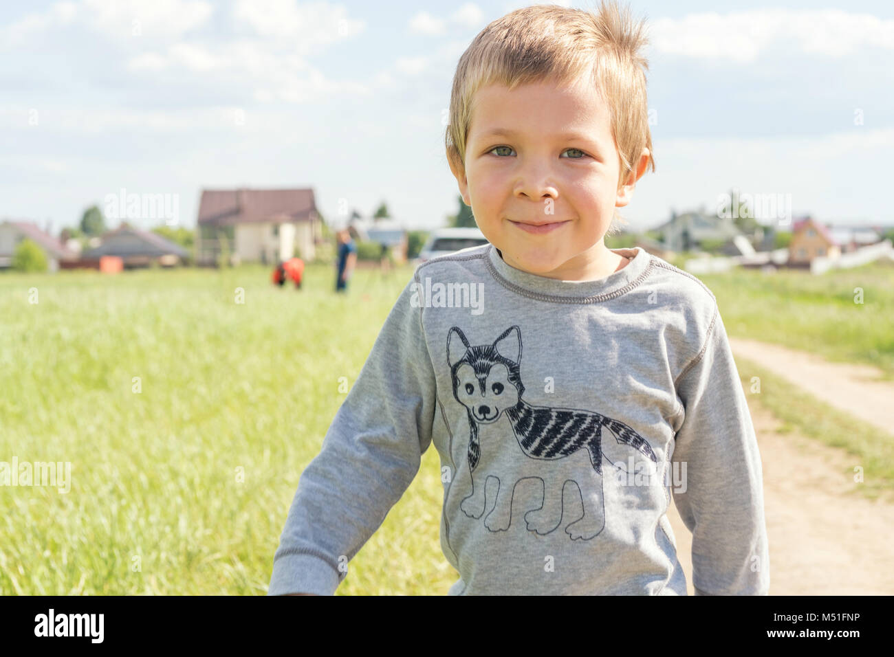 Happy boy running on the field Stock Photo - Alamy
