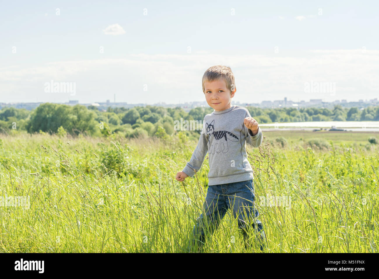 Happy boy running on the field Stock Photo - Alamy