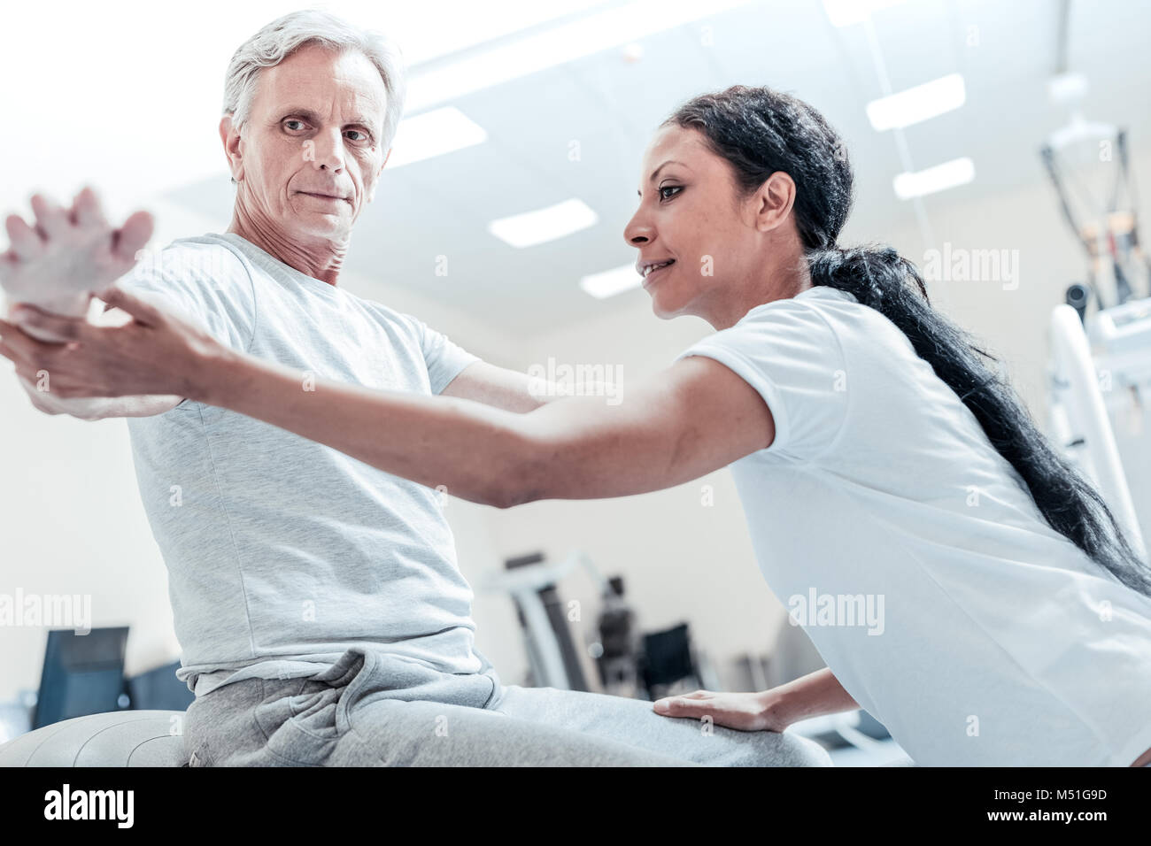 Determined baby-boomer training his arms Stock Photo - Alamy