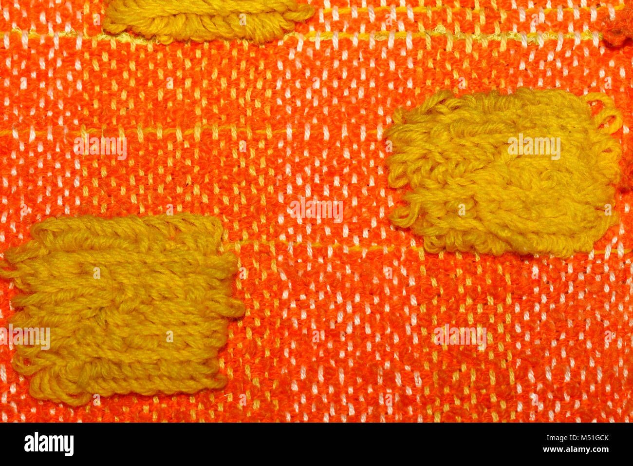 Textured woollen woven piece of material in bright colourful colours ...