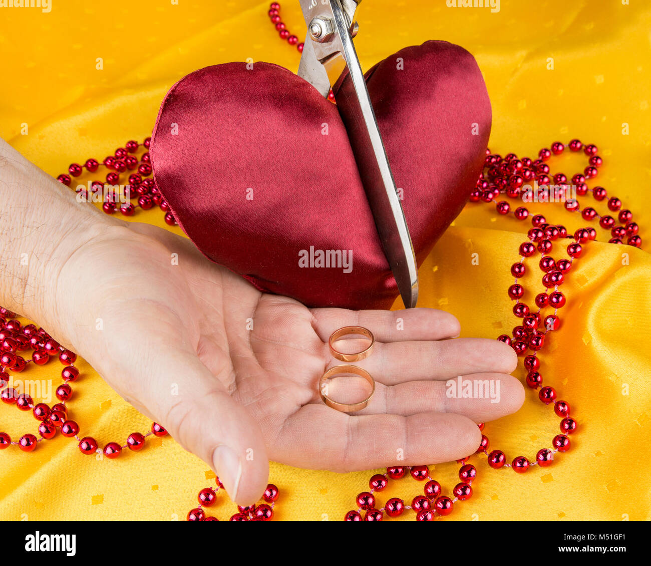 Satin heart cut with scissors. Broken heart. Divorce concept. Couple ...