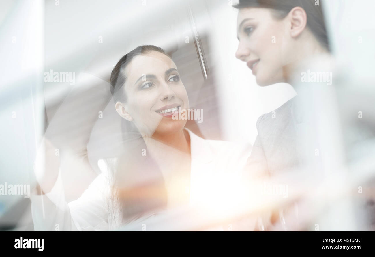 behind the glass.colleagues sitting at your Desk Stock Photo - Alamy