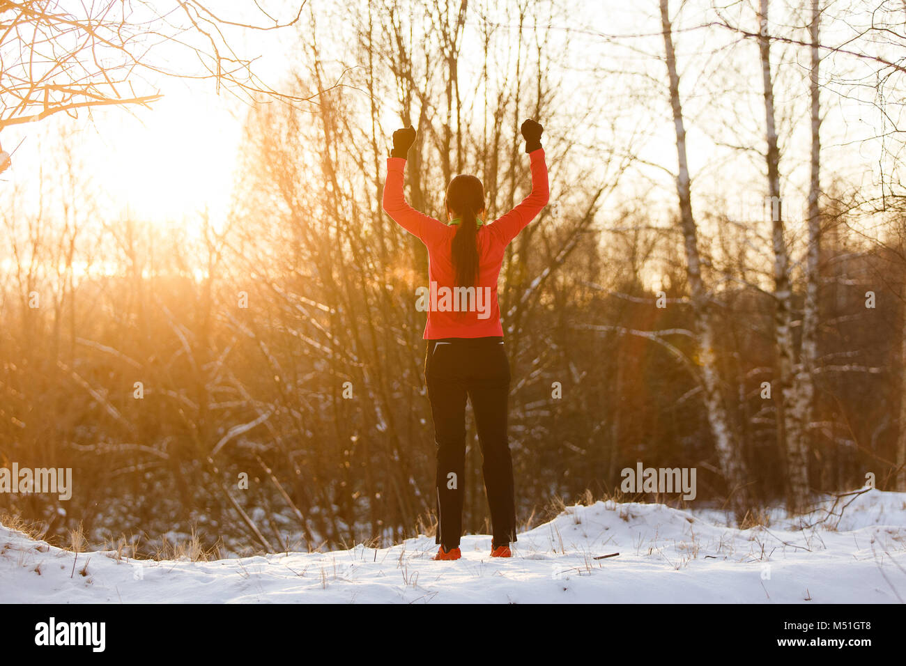Picture from back of sporty woman with arms raised Stock Photo - Alamy