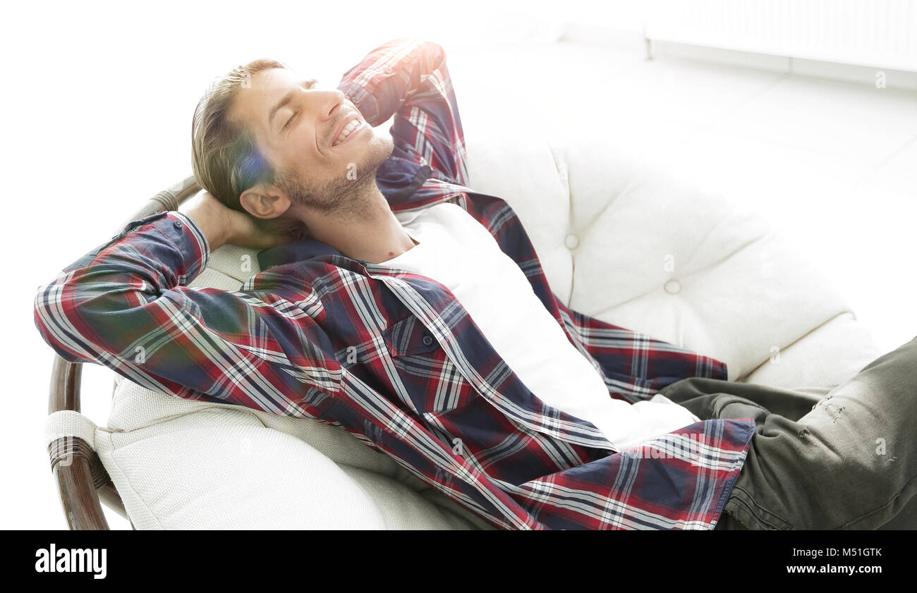 modern guy is resting sitting in a large comfortable chair. side Stock ...