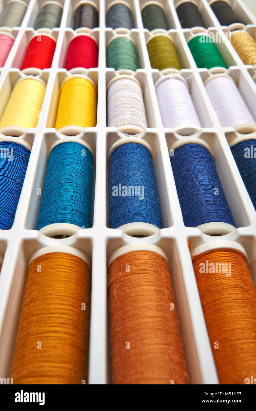 Sewing threads multicolored background closeup Stock Photo - Alamy