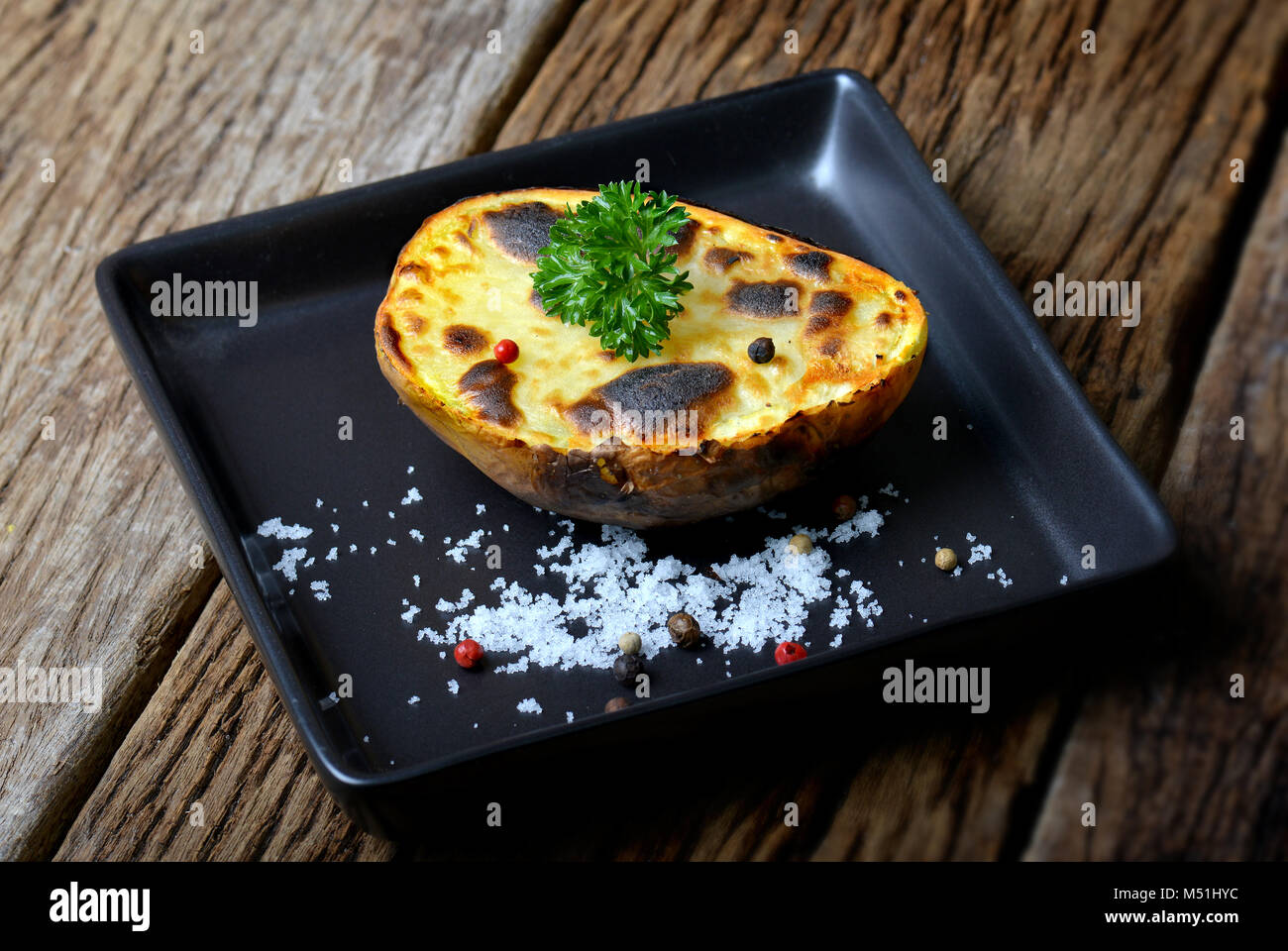 Potato baked and grill with charcoal fire and salt for appertizer in ...