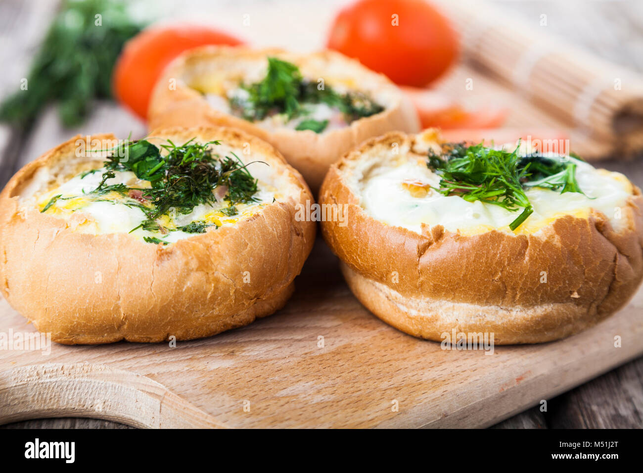 Scrambled eggs with cheese and bacon in a bun. Tasty breakfast Stock ...