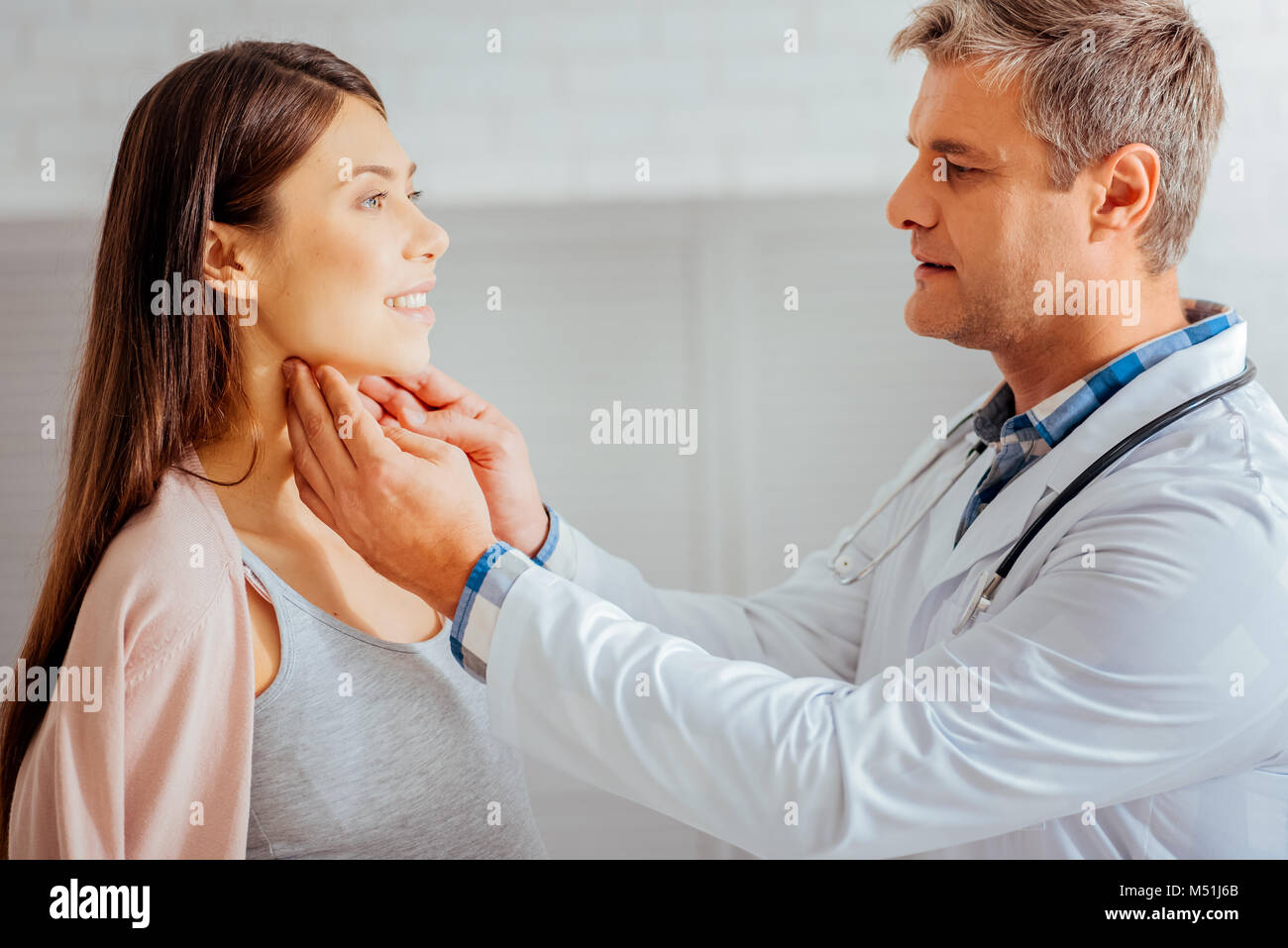 Male doctor checking lymph nodes of pregnant woman Stock Photo - Alamy