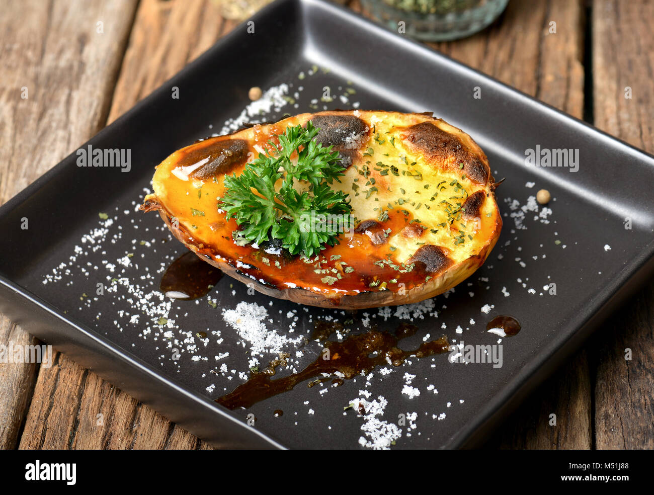 Potato baked and grill with charcoal fire add BBQ sauce for appertizer ...
