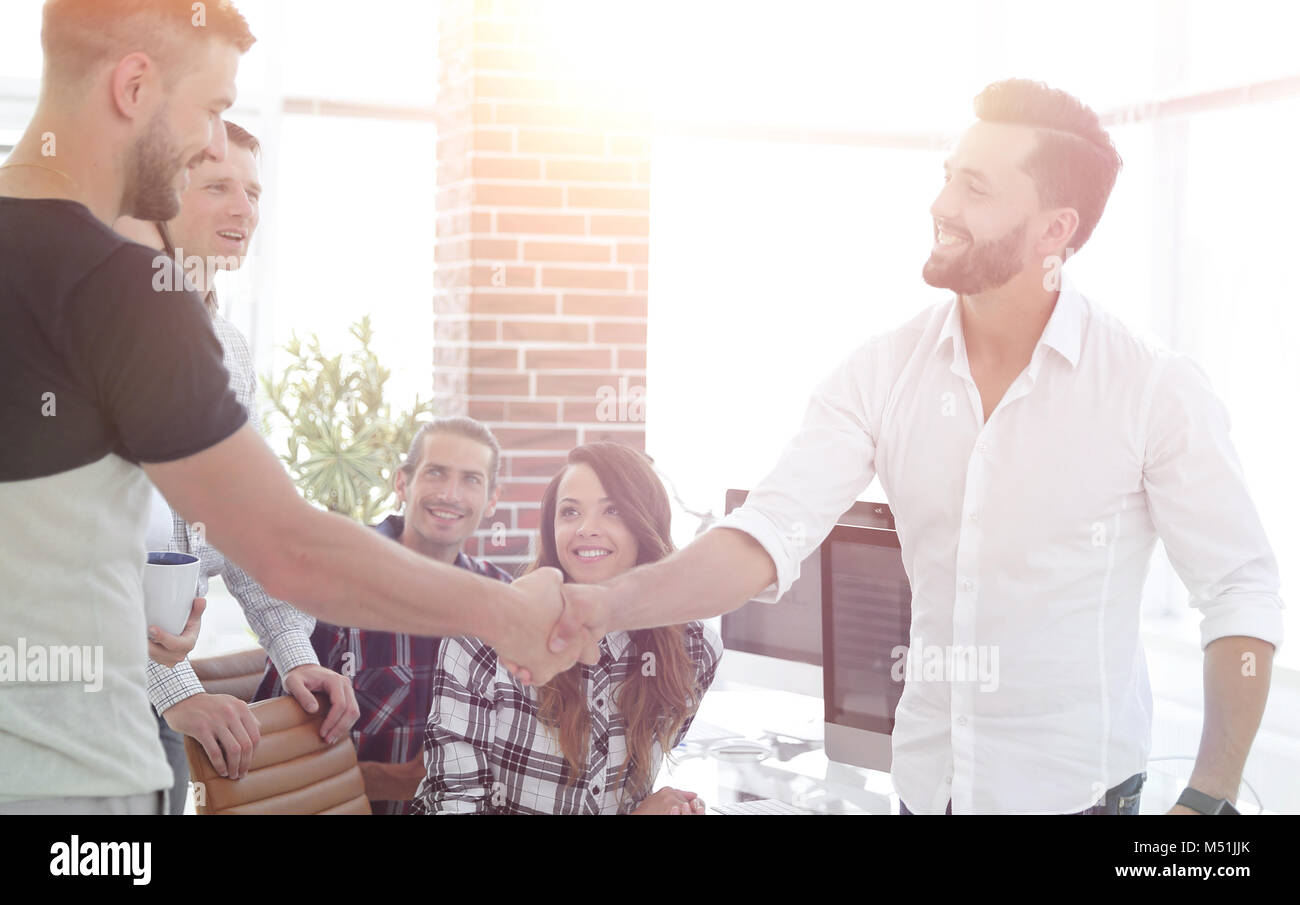 welcome handshake colleagues in creative office Stock Photo - Alamy
