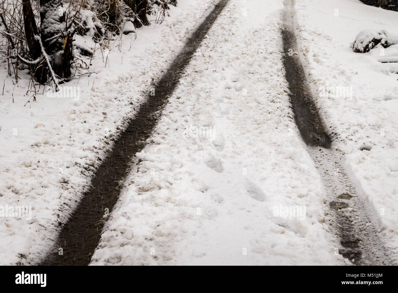 background texture of dirt road covered with snow and tire tracks Stock ...