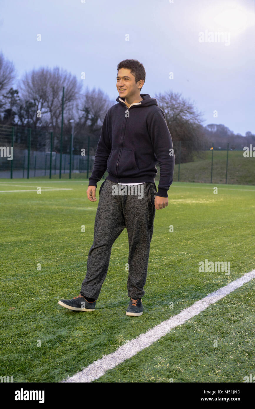school students having a football lesson to improve their skills at ...