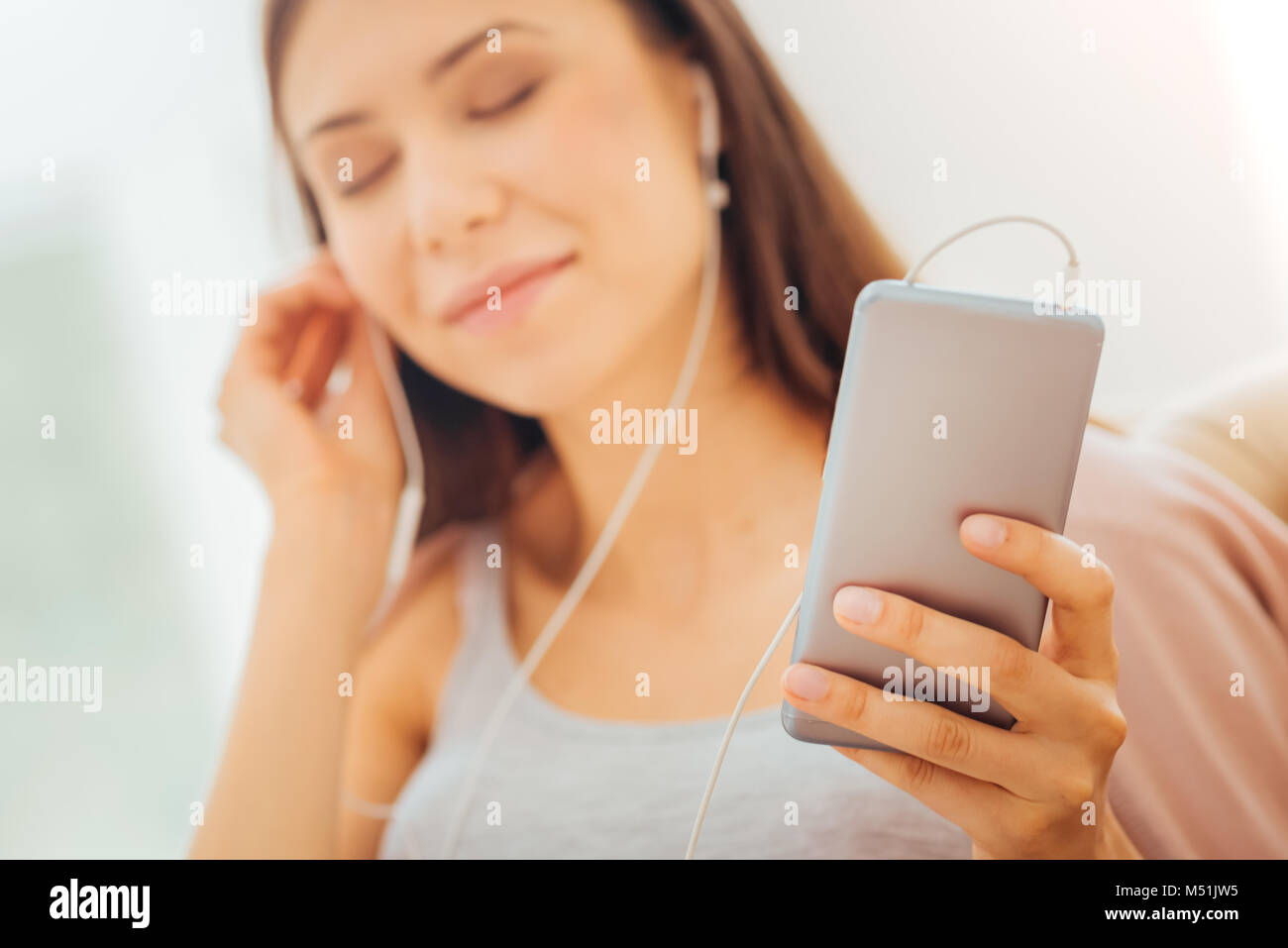 Woman listening music closing hi-res stock photography and images - Alamy