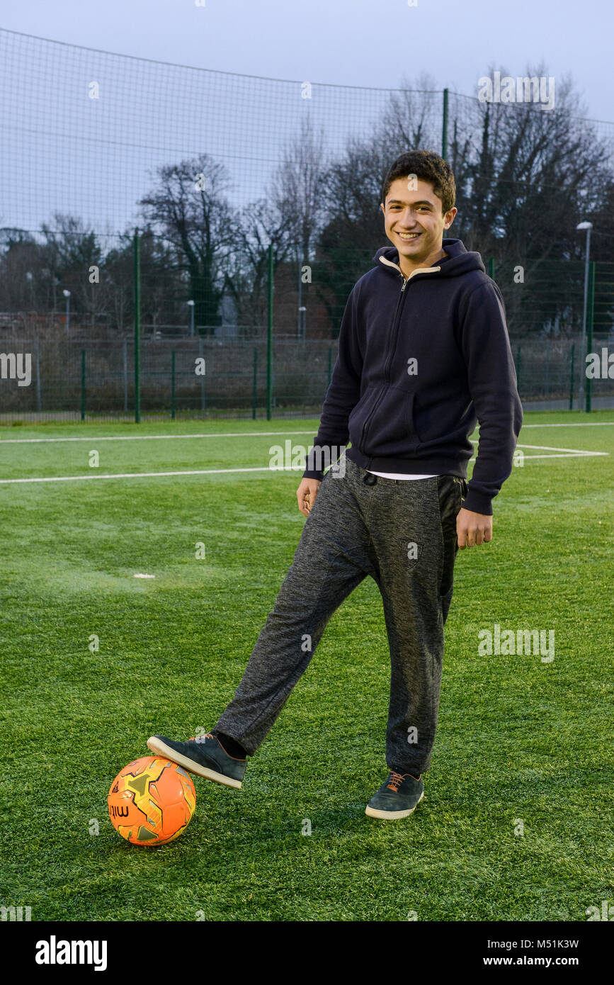 school students having a football lesson to improve their skills at ...