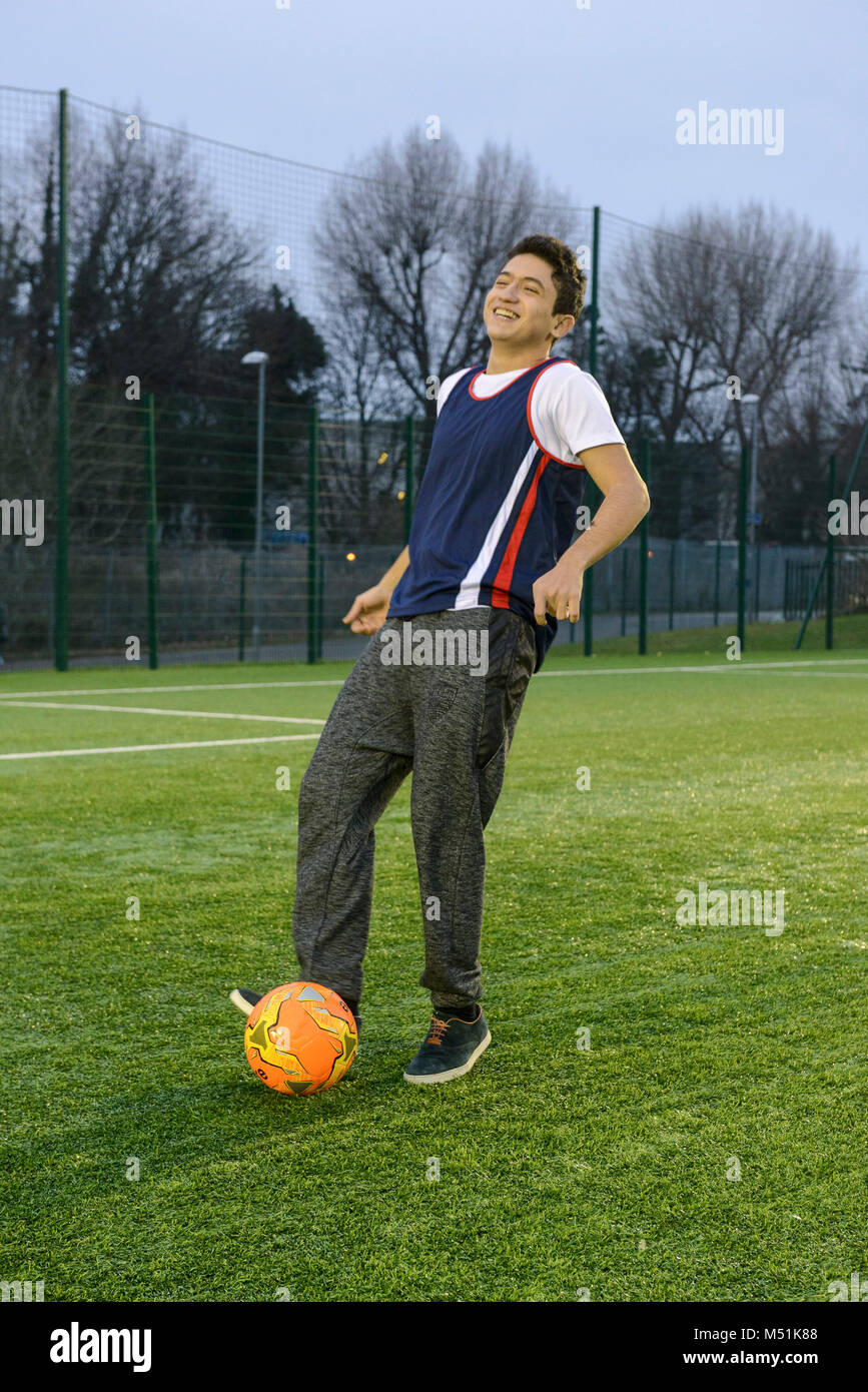 school students having a football lesson to improve their skills at ...