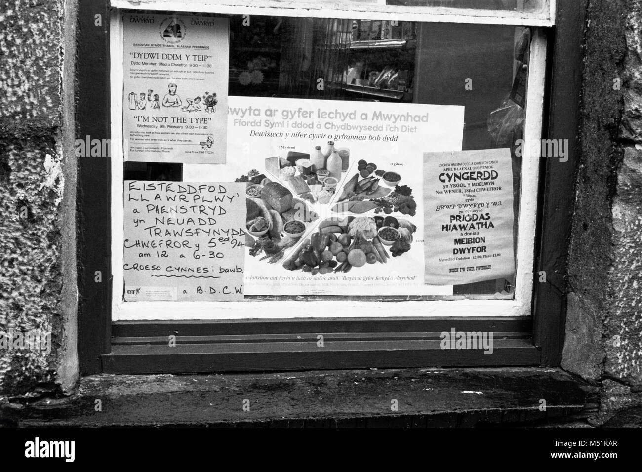 Welsh language poster in village shop window advertising small ...
