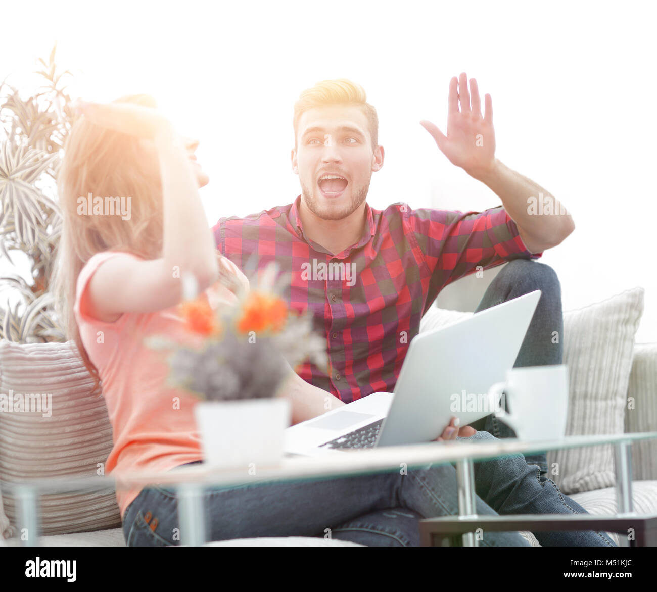 happy young couple giving each other a high five Stock Photo - Alamy