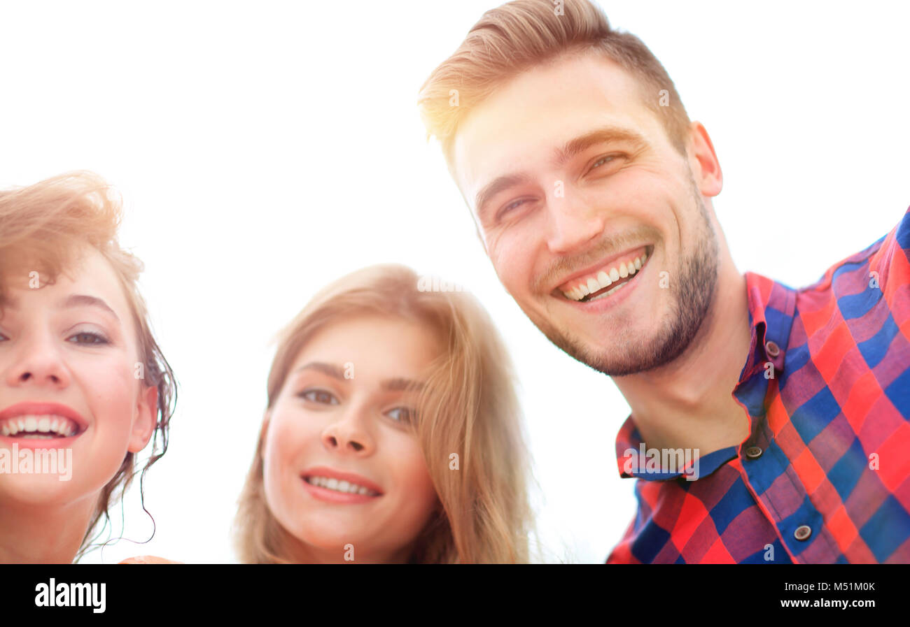 closeup of three young people smiling on white background Stock Photo ...