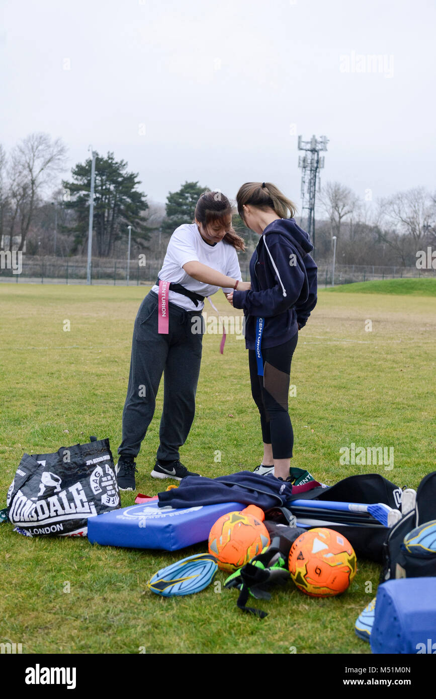 school students having a football lesson to improve their skills at ...