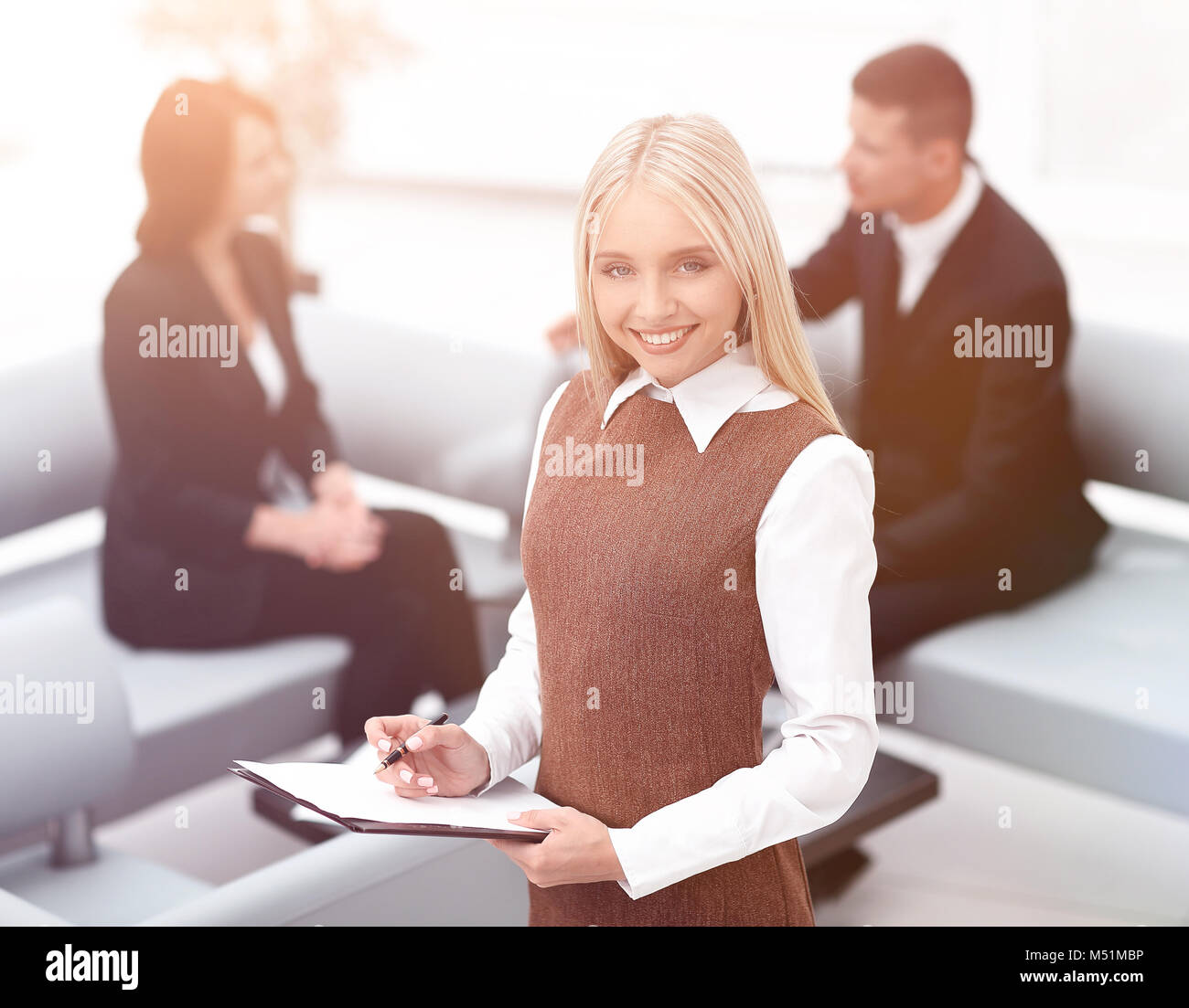 young woman assistant standing in the lobby of the modern office Stock ...