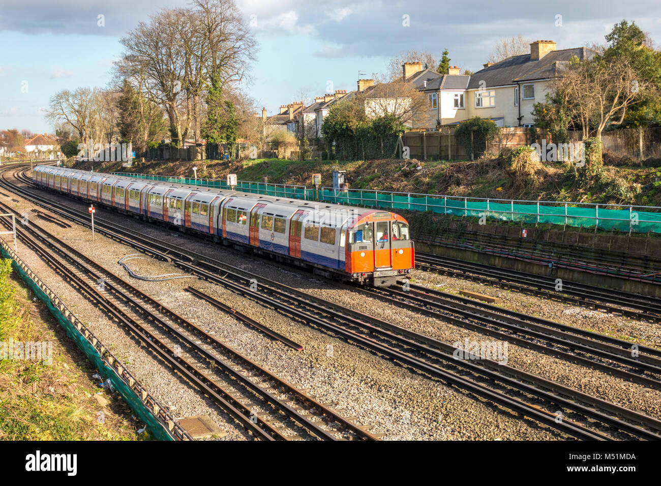 London Underground (LUL) tube train, travelling overground, approaching ...