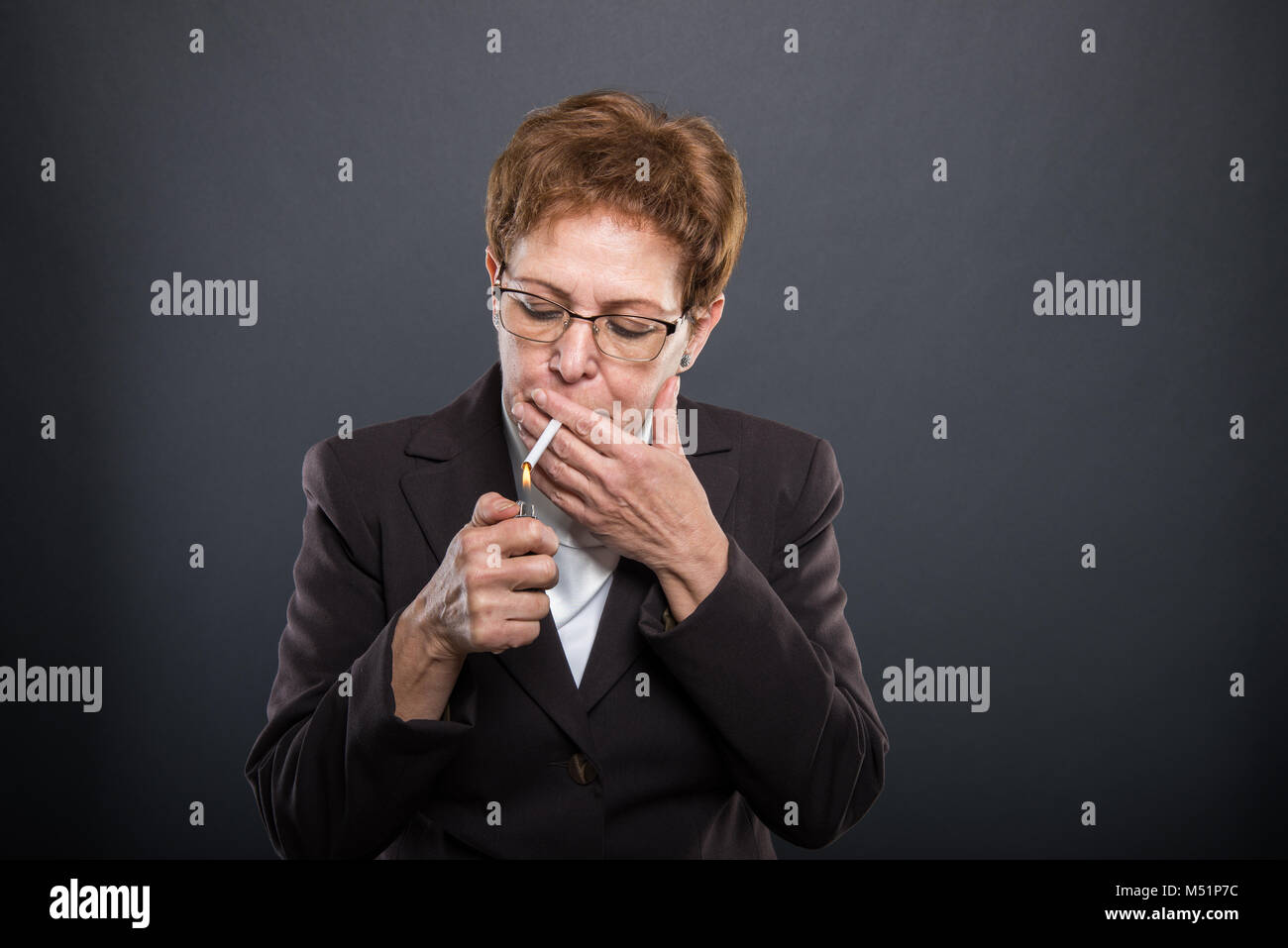 Beautiful woman lighting cigarette hi-res stock photography and images ...
