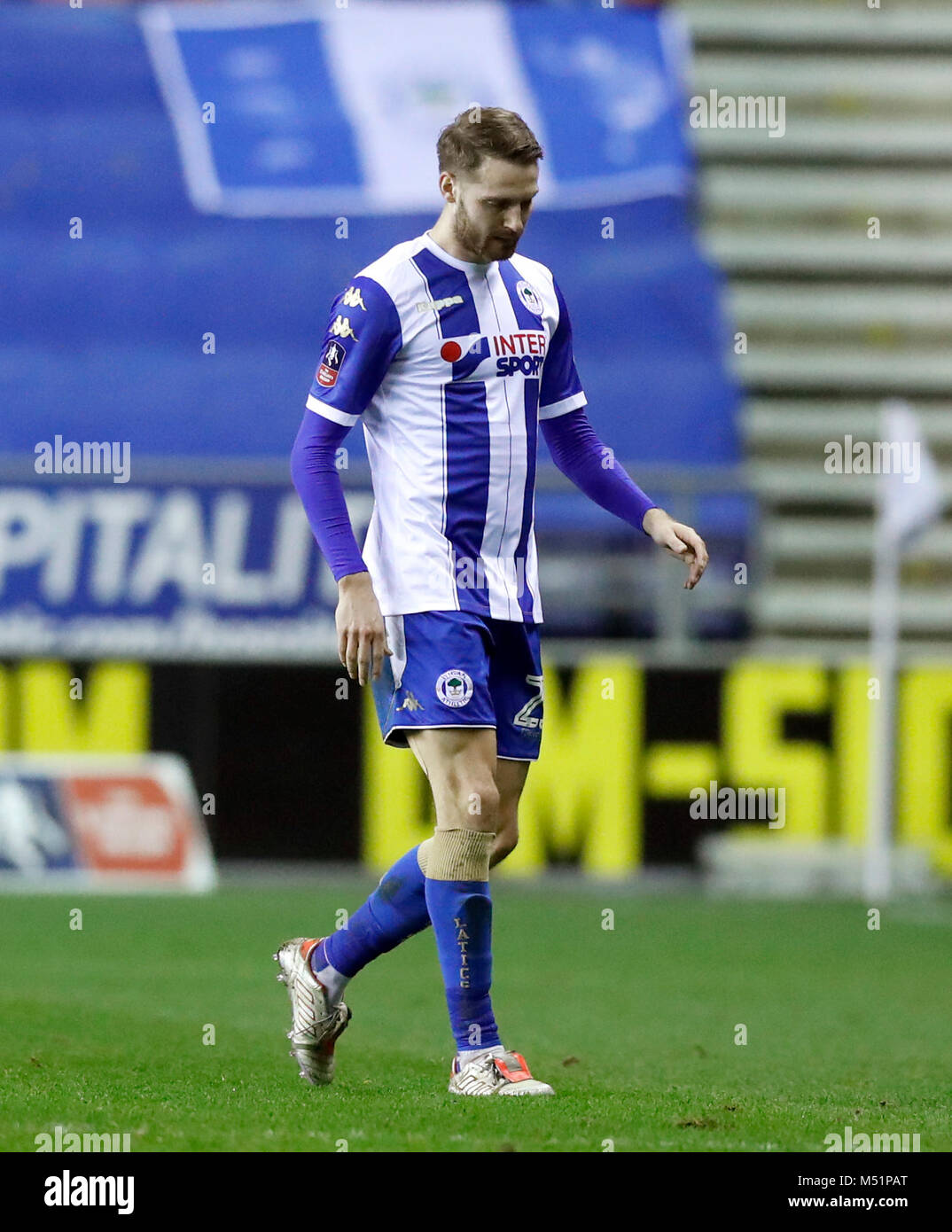 Wigan Athletic's Nick Powell walks off dejected after picking up an ...