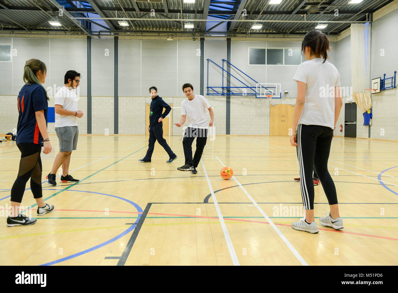school students playing sports in the indoor sports hall at their ...
