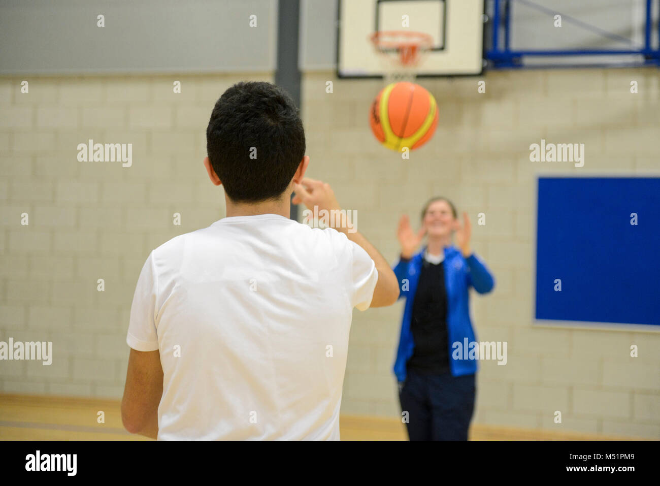 school students playing sports in the indoor sports hall at their ...