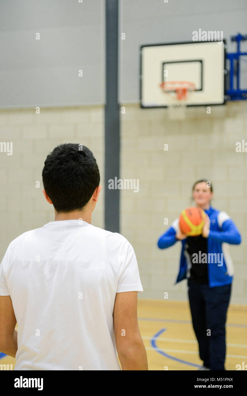 school students playing sports in the indoor sports hall at their ...