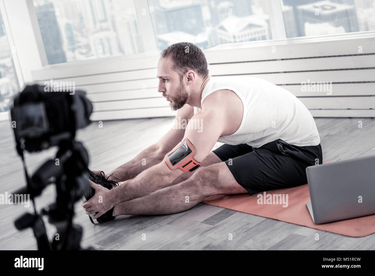 Tired male blogger tipping before training Stock Photo - Alamy