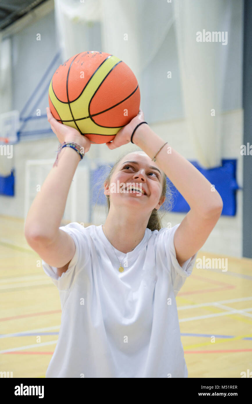 school students playing sports in the indoor sports hall at their ...